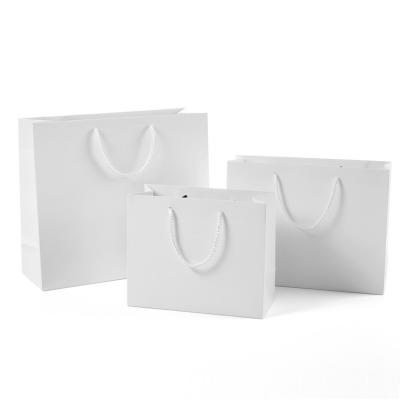 China Customized Printed Ribbon Jewelry Paper Gift Bags With Bow Custom Logo Luxury Ribbon Handle Shopping Packaging Bag for sale