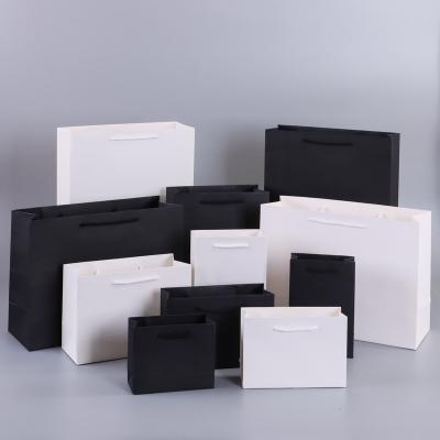 China Factory Direct Supply Customized Logo Luxury Paper Gift Bag Clothes Packaging Paper Shopping Bag With Handle for sale