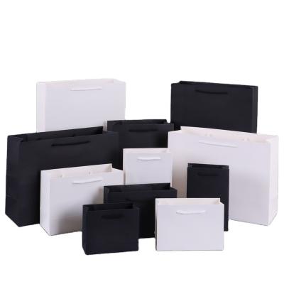 China Luxury Custom Gold Hot Stamping Retail Shopping Gift Packaging Boutique Matte Black Paper Bag With Your Own Logo for sale