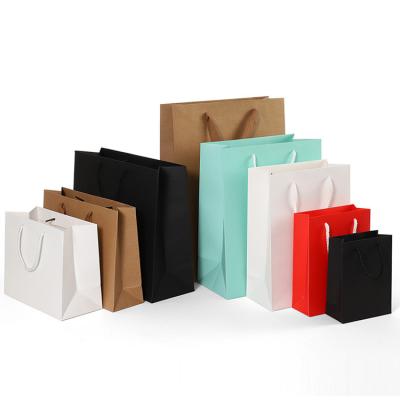 China Luxury European Style Ribbon Handle Boutique Shopping Packaging Bag For Clothes Custom Logo Kraft Paper Gift Bags With Handles for sale