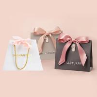 China Printed Boutique Paper Bags Biodegradable And Recyclable With Ribbon Handles for sale