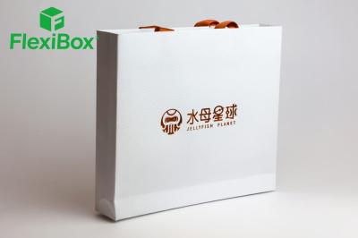 China Branded White Specialty Paper Tote Bag with Orange Flat-Cord Handles and Custom Graphic for sale