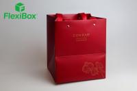 China Premium Red Hotel Gift Bag with Gold Hot-Stamped Logo and Reinforced Metal Eyelets for sale