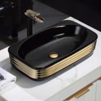China Custom Design Counter top Matte Black Ceramic Bathroom Sink Modern Black and Gold Color Art Wash Basin for sale