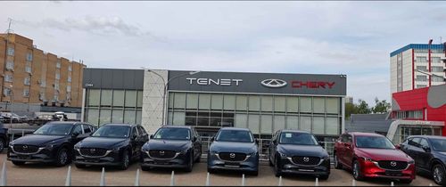 Russia automotive dealership exterior with Chery and TENET showroom