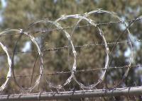 China Roll Type Razor Barbed Wire Fence Fixed With Clips Single Or Cross Coil for sale