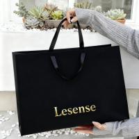 China Redefine Luxury Packaging Custom Branded Black Paper Gift Bags for sale