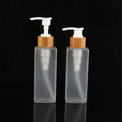 China Frosted Clear Screw Plastic Lotion Bottles With Bamboo Pump Shell for sale