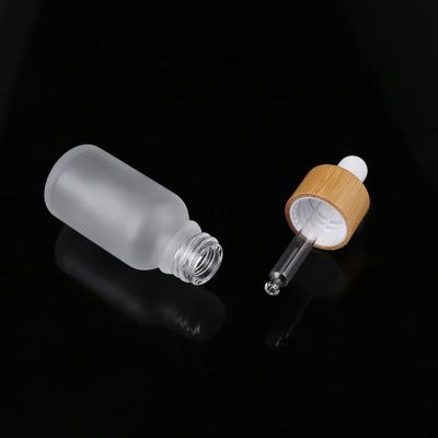 China Hot sale frosted amber eye cream essential oil cbd oil cosmetics lotion glass bottle with bamboo dropper cap for sale