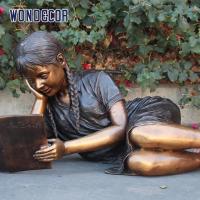 China Customized garden decoration, life-size bronze statue of a girl lying on her side reading a book for sale