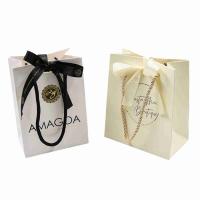 China FSC 250gsm Cosmetics Perfume Shopping Printed Paper Gift Bags With Ribbon Handles for sale