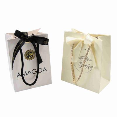 China FSC 250gsm Cosmetics Perfume Shopping Printed Paper Gift Bags With Ribbon Handles for sale