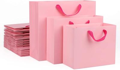 China OEM Boutique Cardboard Fancy Kraft Paper Shopping Bags With Handle 210gsm for sale