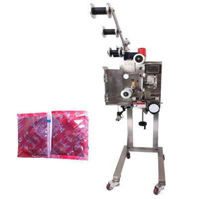 China Paper Plastic Aluminum Foil Desiccant Inserter Machine 100 Packets/Minute for sale