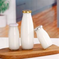 China Round Screen Printing Milk Beverage Empty Glass Bottles 200ml 250ml 500ml 1000ml With Cap for sale