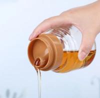 China 350ml 500ml Honey Glass Bottle Food Grade Tip Cap Round Honey Canned Sub Bottle for sale