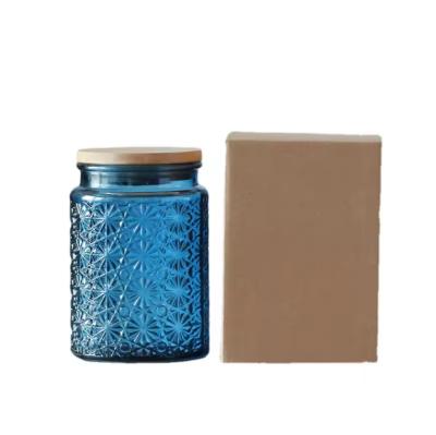 China Embossed Colored 700ml Glass Sealed Jar Household Kitchen Storage Container With Lid for sale