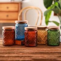 China Embossed Colored 700ml Glass Sealed Jar Household Kitchen Storage Container With Lid for sale