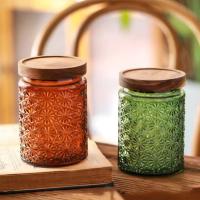 China Embossed Colored 700ml Glass Sealed Jar Household Kitchen Storage Container With Lid for sale
