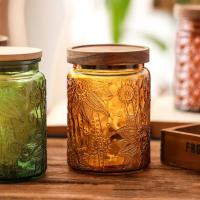 China Embossed Colored 700ml Glass Sealed Jar Household Kitchen Storage Container With Lid for sale