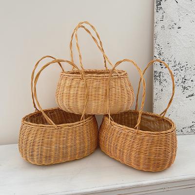 China Oval Shape Handle Flower Basket Indonesian Rattan Woven Mini Waterproof Picnic Basket for sale