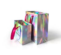China Custom Logo Luxury Glossy Pink Ribbon handle Paper Bag Gift Craft Jewelry Cosmetic Packaging Holographic Paper Shopping for sale