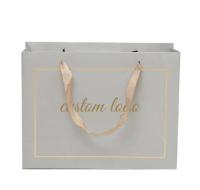 China Cardboard Paper Shopping Bags Custom Luxury Gift Bags With Logo Handles for sale