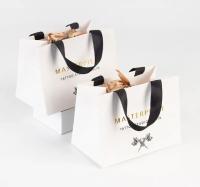 China Art Paper Shopping Bag Packaging Kraft Paper Bag With Embossed Logo for sale
