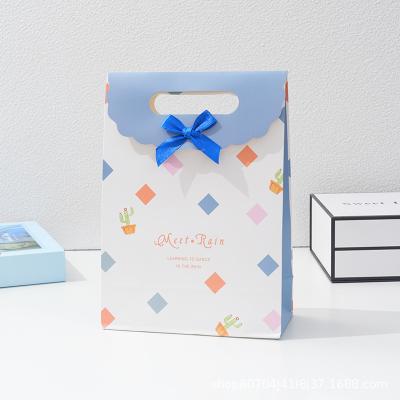 China Elegant Bow Handle Paper Gift Bags With Velcro Closure Minimalist Flap Style Packaging For Festive Gifts And Events for sale