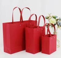China Luxury Red Rivet Handle Paper Bags Custom Logo Boutique Shopping Bags For Fashion Gifts for sale