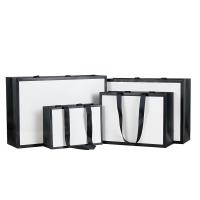 China Elegant Textured Gift Paper Bags Premium Shopping Bags for Clothing Stores Gifting for sale