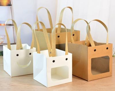 China Smiley Face Square Paper Gift Bags Handle Tote Bags For Kids Gifts Floral Packaging for sale