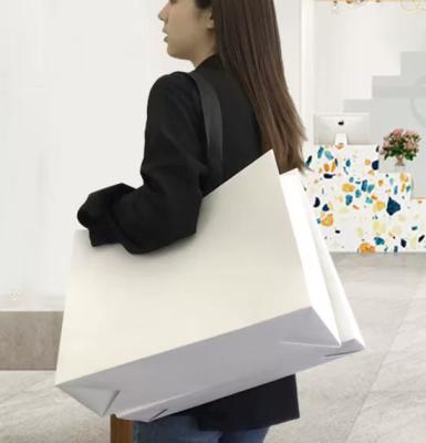 China Custom Printed White Kraft Paper Bags with Rope Handles for Boutiques for sale