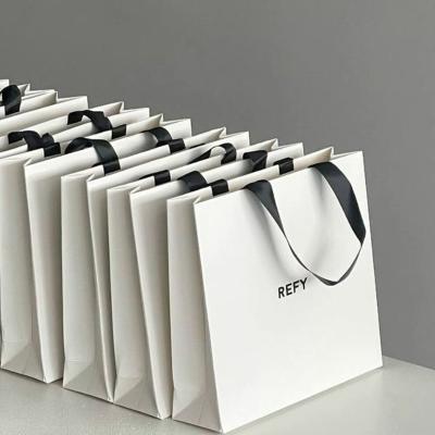 China Custom Logo Kraft Gift Bags with Ribbon Handles for Boutiques for sale
