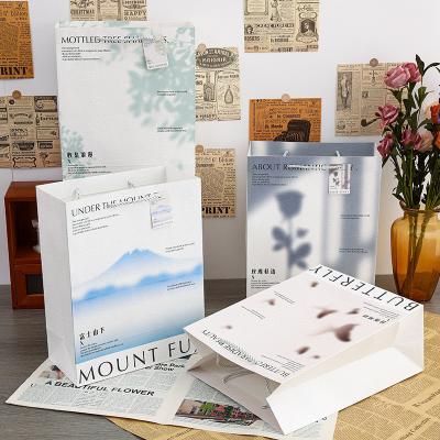 China White Kraft Embossed Gift Bag Birthday Gift Packaging Handbag Holiday Gift Paper Bag for sale