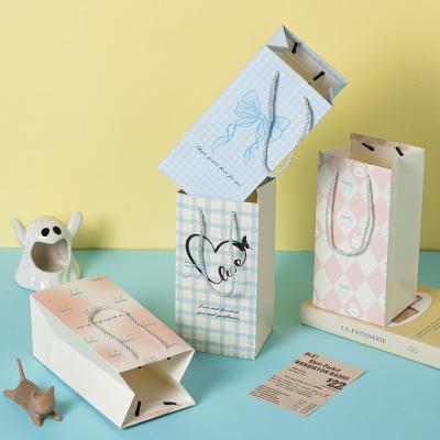 China Cute Cartoon Exquisite Gift Packaging Paper Bag Gift Handbag Custom Pattern Printing Cardboard Bag for sale