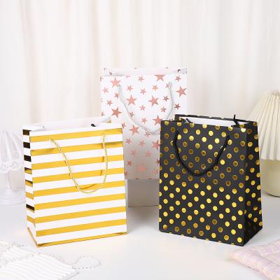 China Hot Stamping Polka Dot Paper Bag Thick White Cardboard Handbag Shopping Gift Bag Gift Packaging for sale