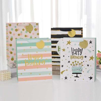 China New Design Birthday Gift Bag Packaging English Paper Bag Hot Stamping White Card Handbag for sale