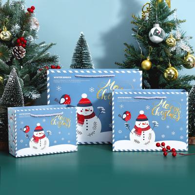 China Merry Christmas Cartoon Gift Bag Collection Snowman Reindeer Themed Packaging Gold Foil Stamping Christmas Tree Decoration Included for sale