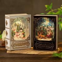 China Christmas Musical Snow Globe Book Light Rotating LED Night Light With Music Box for sale