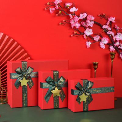 China Festive Red Bow Gift Box Set Premium Christmas Wedding Packaging Gold Star Embellishments Green Satin Ribbons for sale