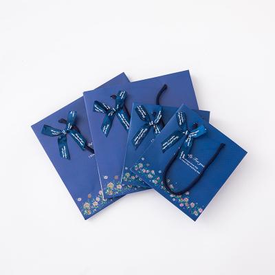 China Cardboard Gift Bag Jewelry Themed Paper Bag With Bowknot And Floral Patterns Ideal For Handbags Gift Returns And Shopping for sale