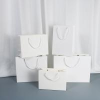 China Solid Color Paper Bag With Logo Printing Thick White Card Shopping Gift Bag Clothing Store Handbag for sale