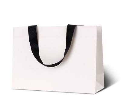 China Embedded Paper Gift Bag Premium Thickened White Card Handled Bag Black Ribbon Handles Luxury Shopping Clothing Packaging Customizable Branding Space for sale