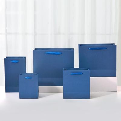 China Simple Bow-shaped Gift Bag Packaging Box Cosmetic Gift Wrapping Bag Tote Gift Paper Bag for sale