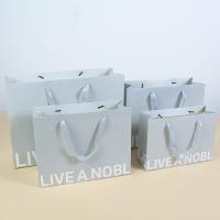 China Thickened Kraft Paper White Cardstock Gift Bags Clothing Store Tote Bags Custom Logo Printing Packaging Bags for sale