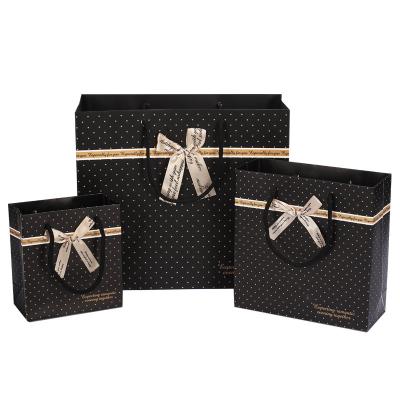 China Black Kraft Paper Bag Clothing Store Ribbon-decorated Packaging Tote Bag Gift Wrapping Handbag for sale