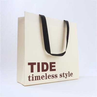 China Kraft Paper Gift Bag Stylish Black Ribbon Handles Ideal for Retail Shopping Branded Packaging Eco Friendly Gifting for sale