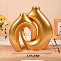 China Embrace Hollow Ceramic Vase for Modern Home Decor for sale