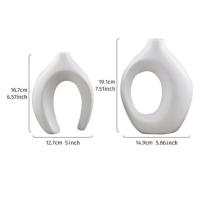 China Embrace Hollow Ceramic Vase for Modern Home Decor for sale